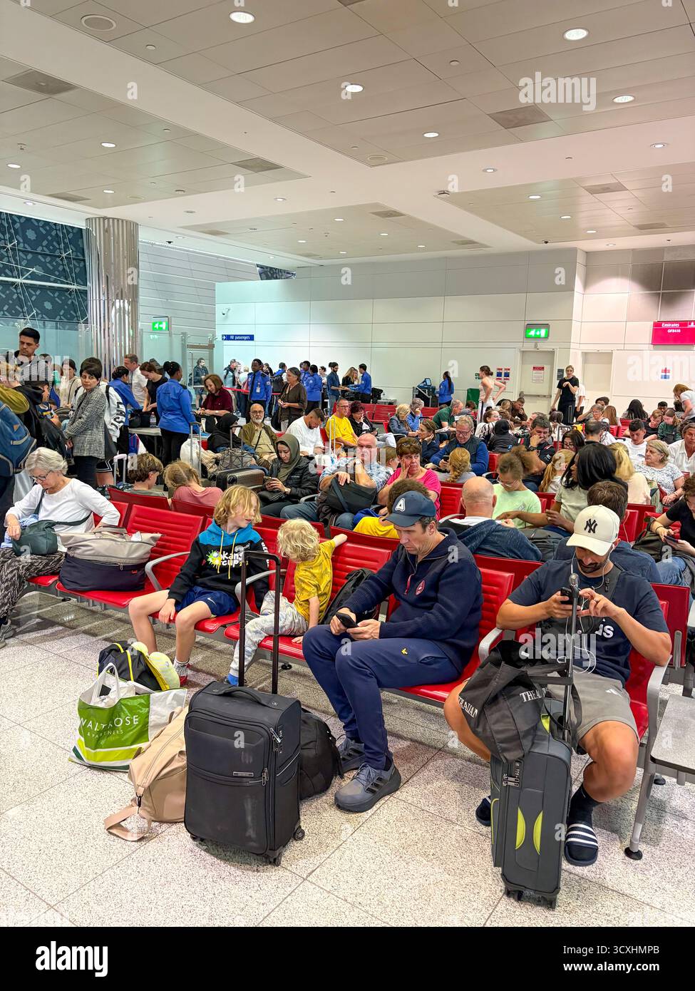 Dubai international airport, passengers at A23 departure gate in ...
