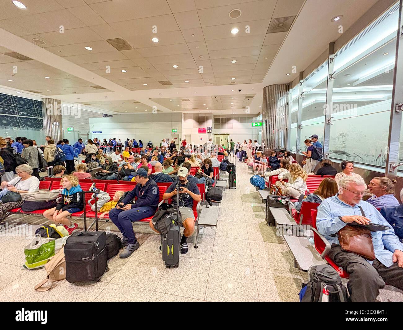 Dubai international airport, passengers at A23 departure gate in ...