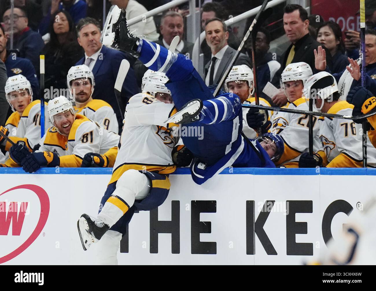 Nashville Predators' Ozzy Wiesblatt (89) hits Toronto Maple Leafs' Jake ...