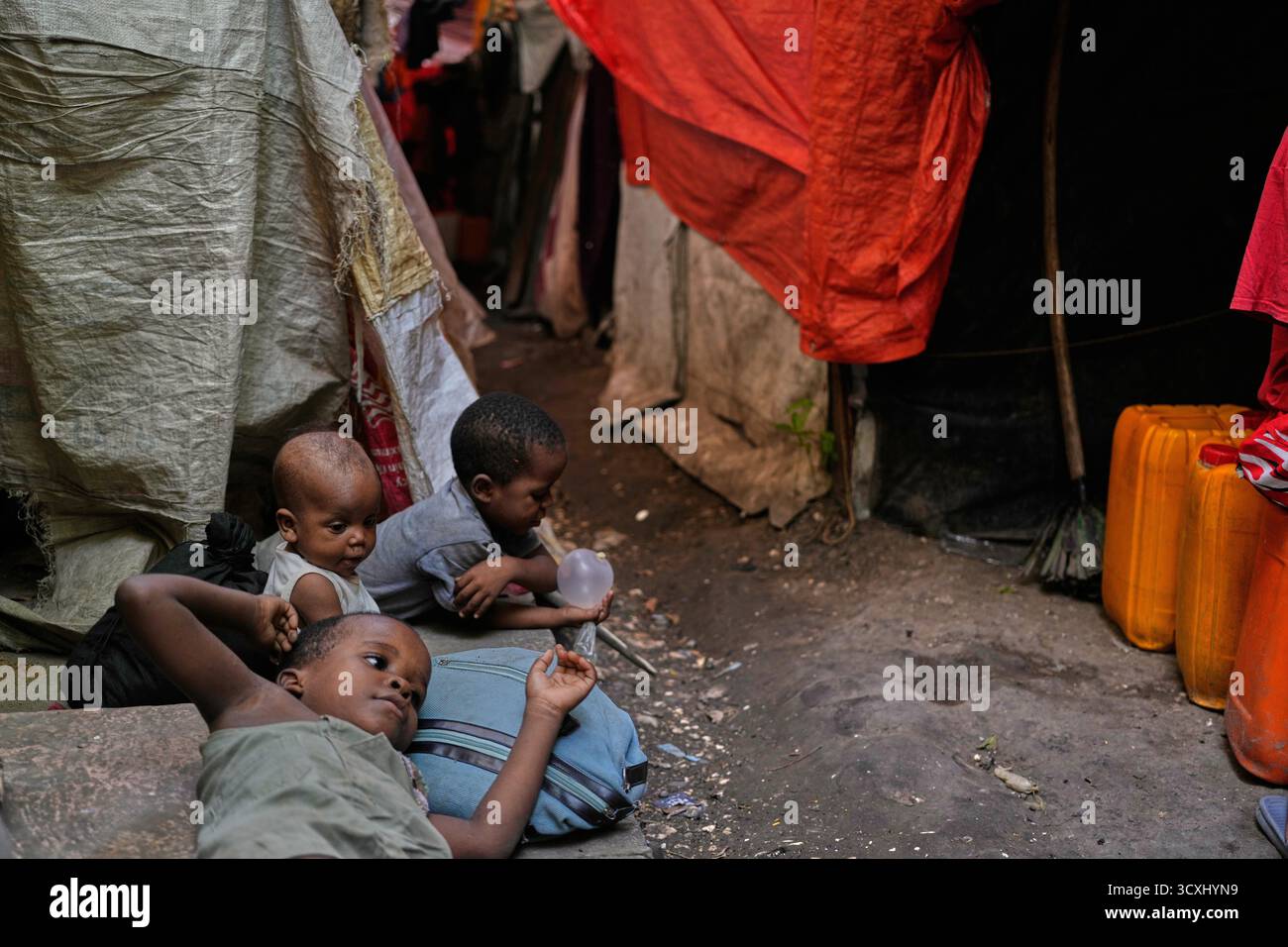 Children relax in a shelter for families displaced by gang violence in ...