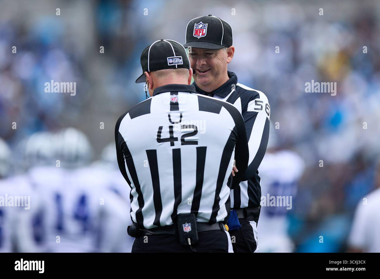 Side judge Allen Baynes (56) chats with umpire Duane Heydt (42) during ...