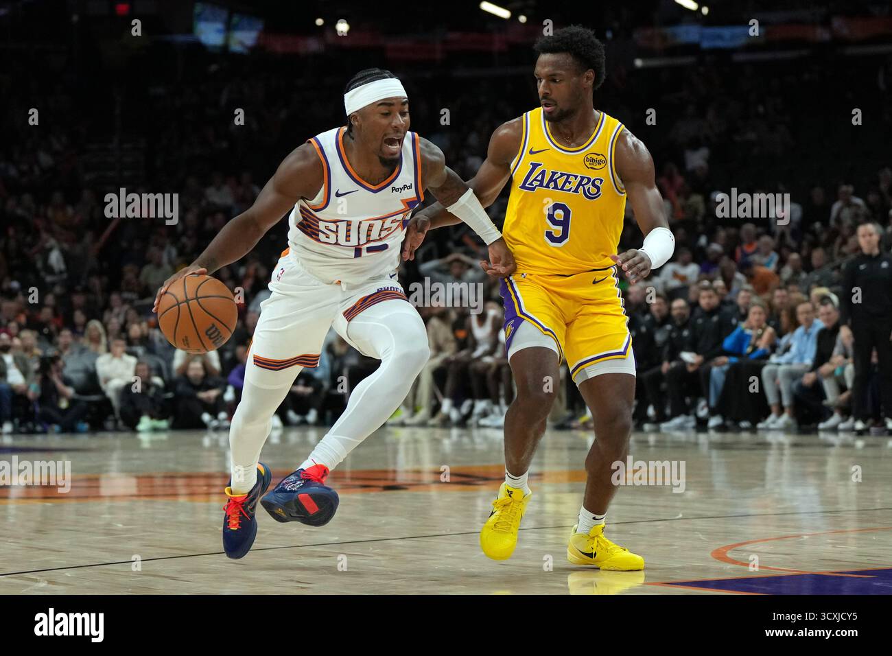 Phoenix Suns guard David Duke Jr., left, drives on Los Angeles Lakers ...