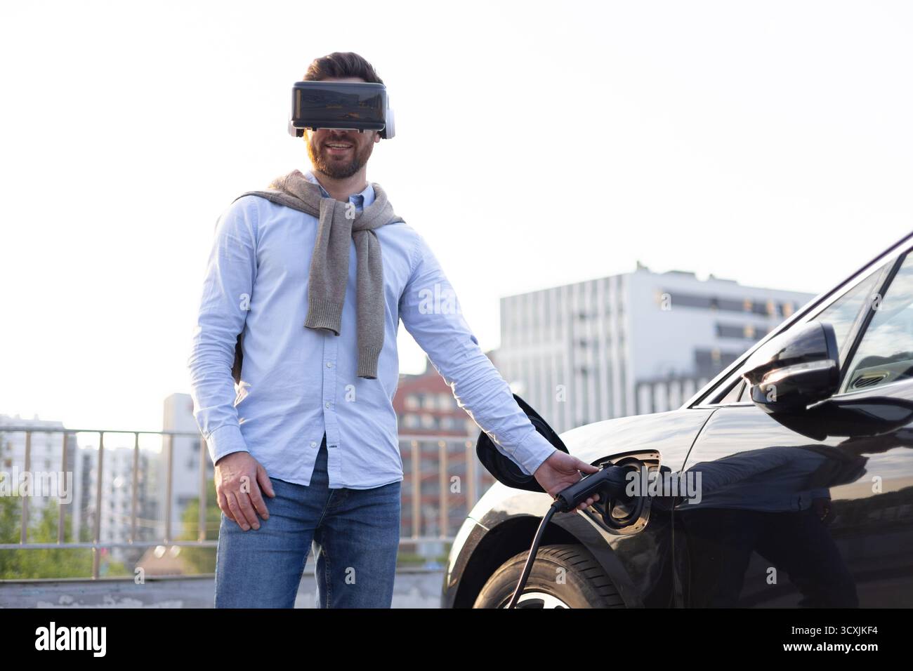 Man Charging Electric Vehicle Stock Photo - Alamy