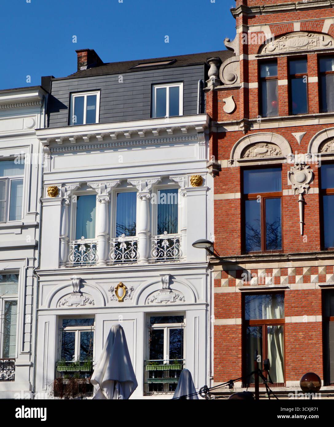 Architectural contrast: a neoclassical white stucco facade with columns ...