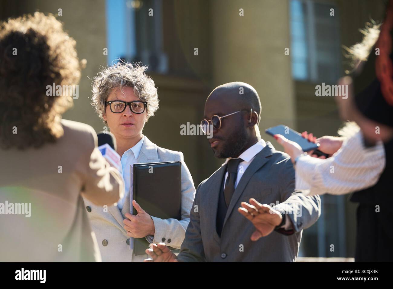 Authority microphone gesturing standing crowd communication hi-res ...