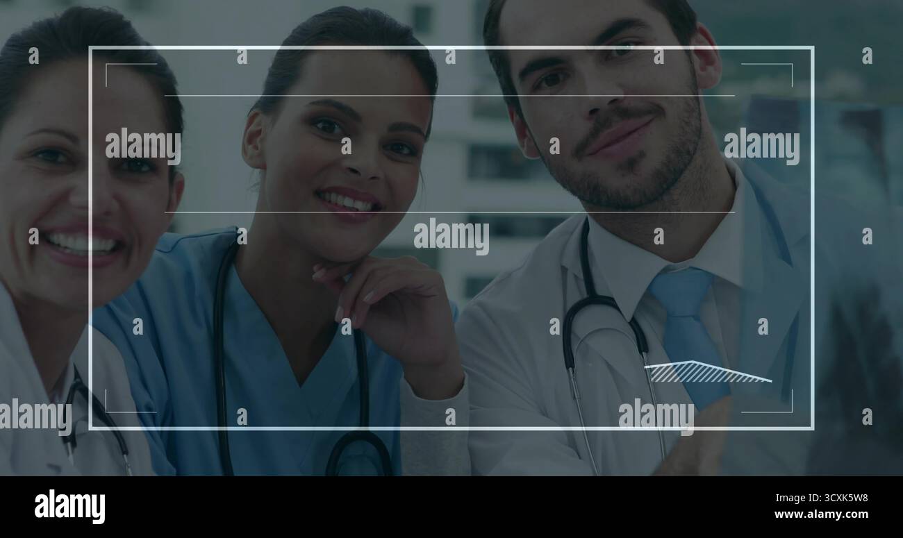 Examining medical team analyzing overlay of x-ray scans on monitor in ...