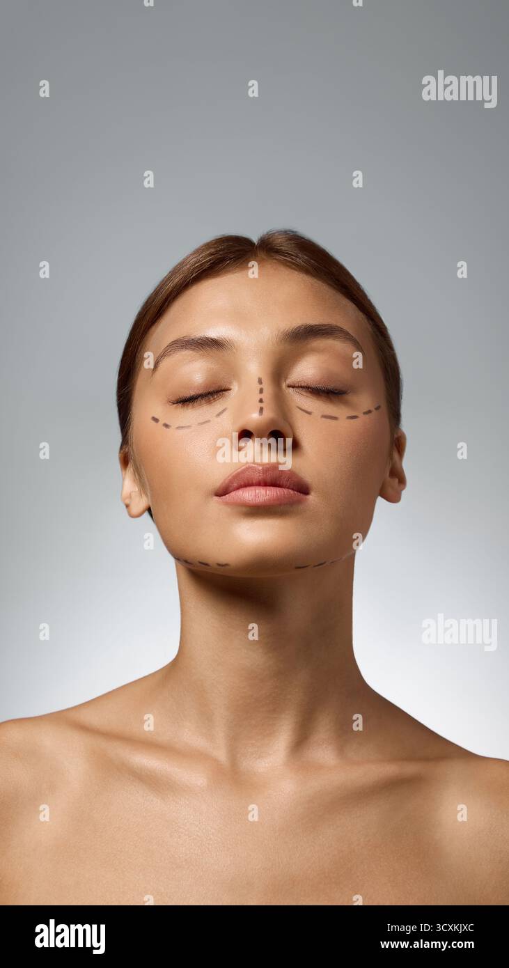 Woman with face markings and closed eyes showing calm trust before ...