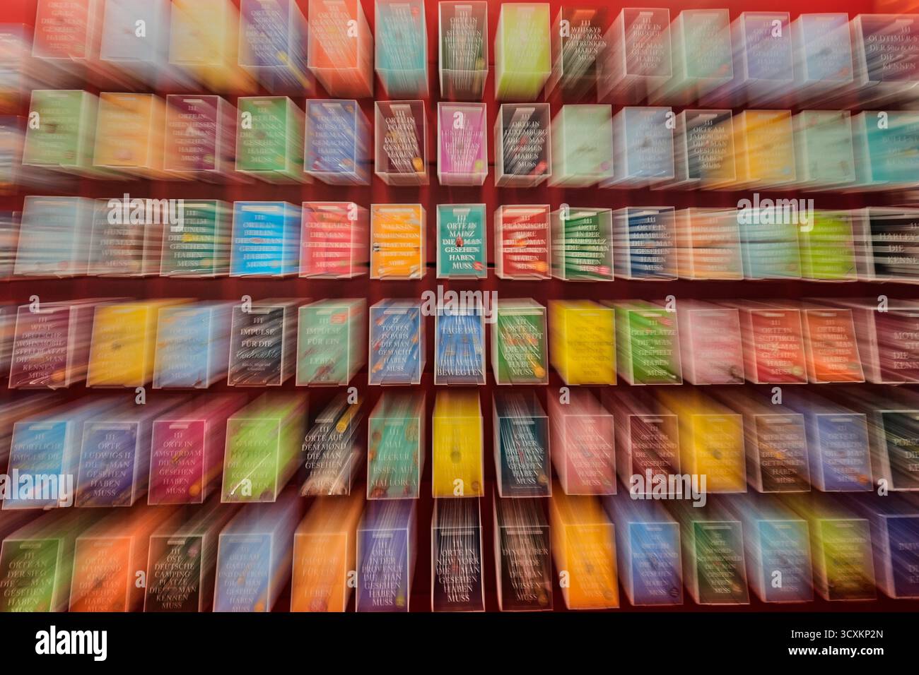 In this image made with a zoom lens and slow shutter speed, a bookshelf ...