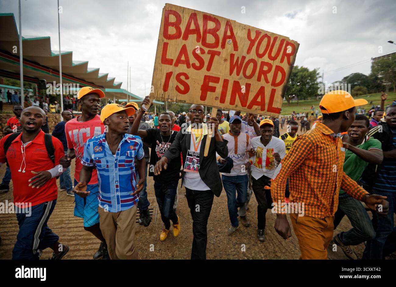 Supporters of opposition leader Raila Odinga march with a placard ...