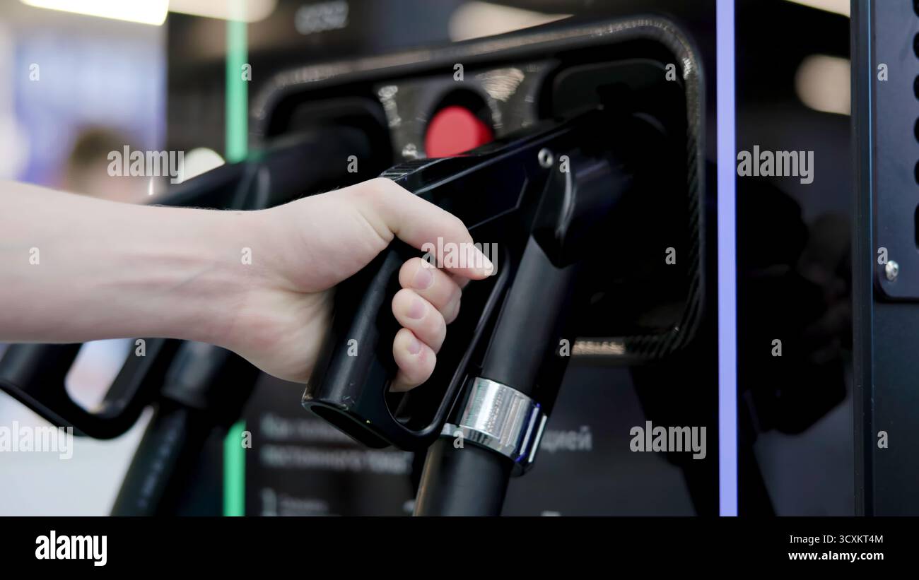 Hand grabbing electric vehicle hi-res stock photography and images - Alamy