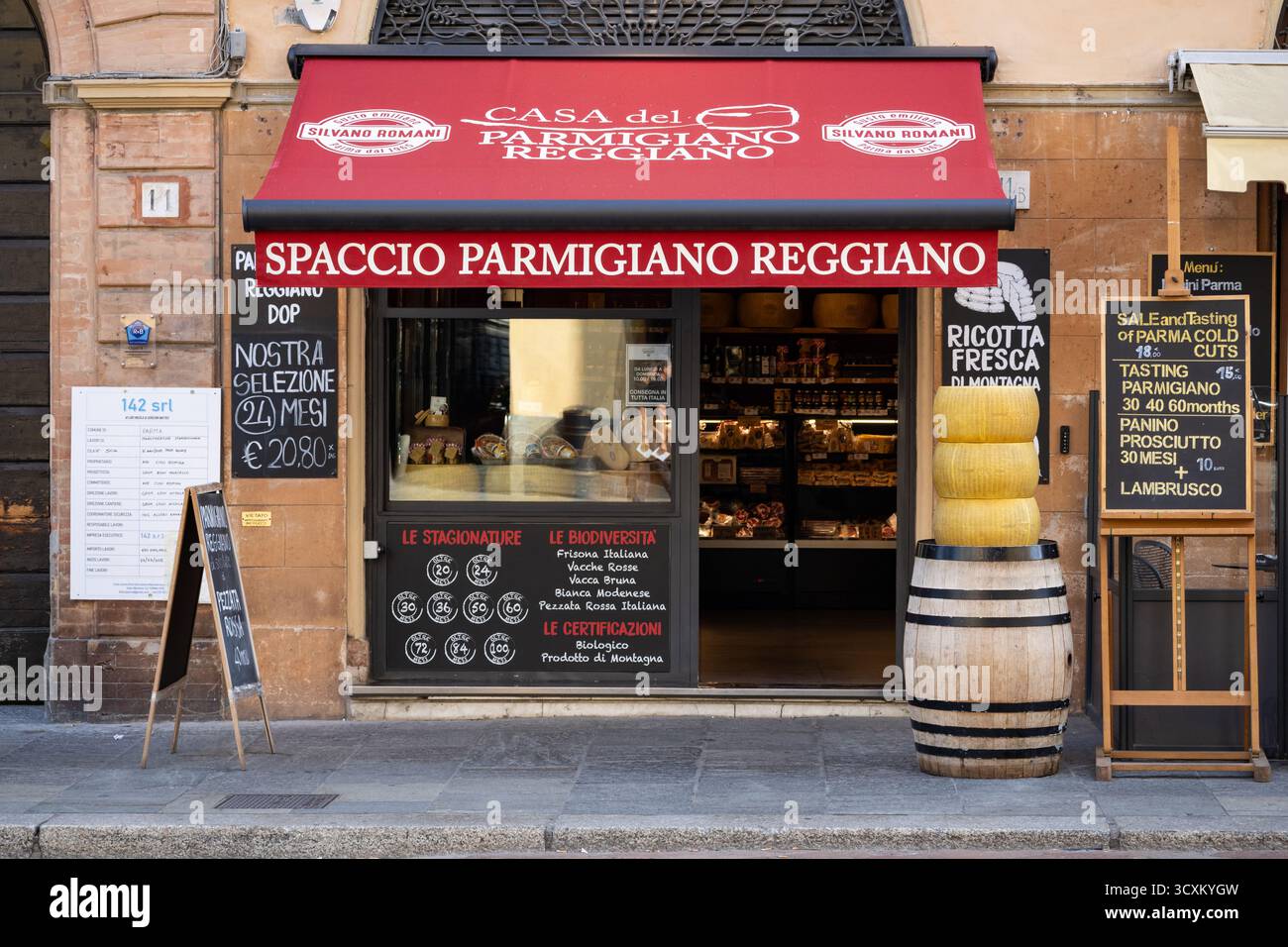 A traditional Italian delicatessen in Parma displays Parmigiano ...