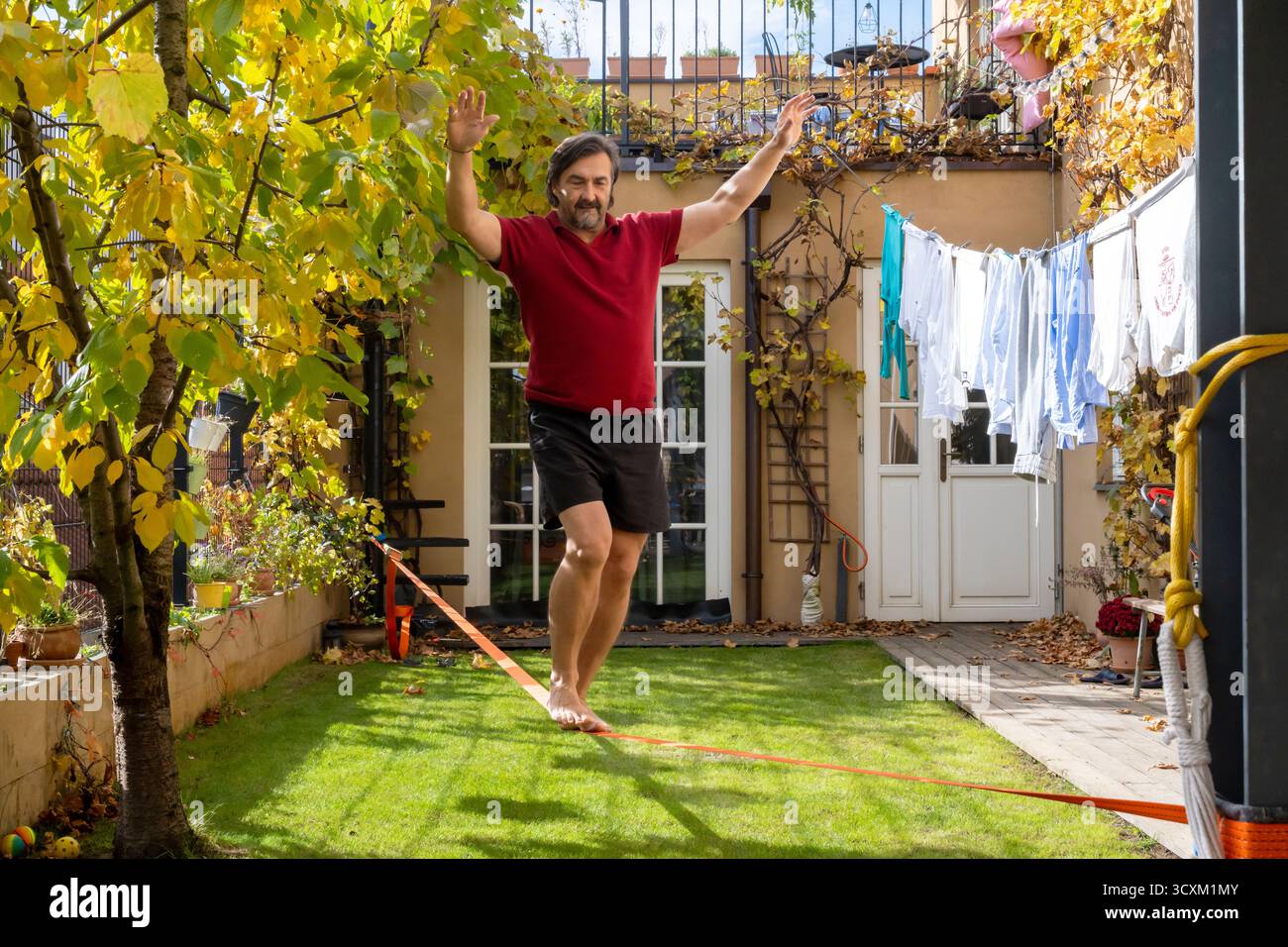 Man 50 walking on the slack line hi-res stock photography and images ...