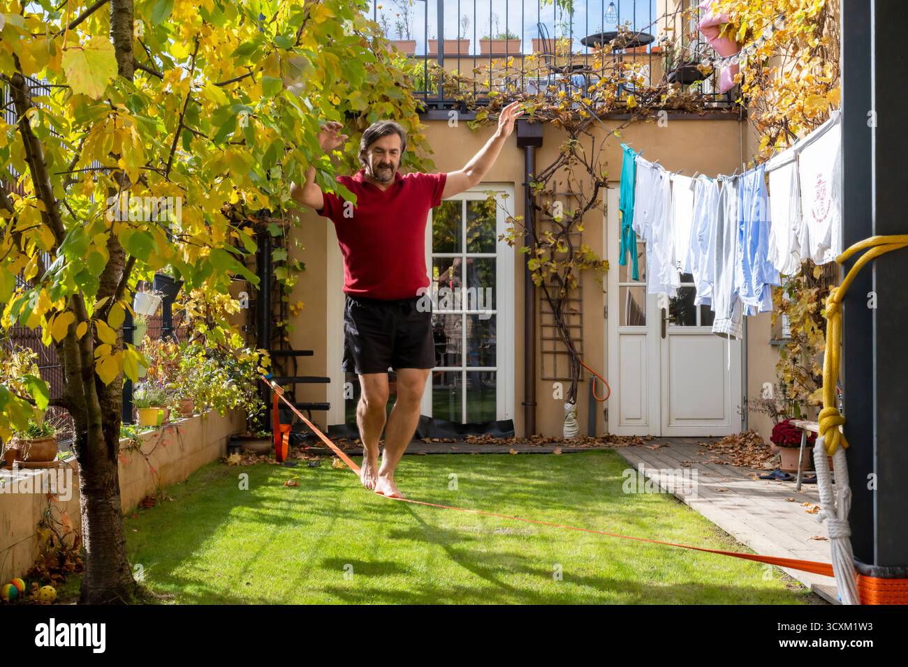 Man 50 walking on the slack line hi-res stock photography and images ...