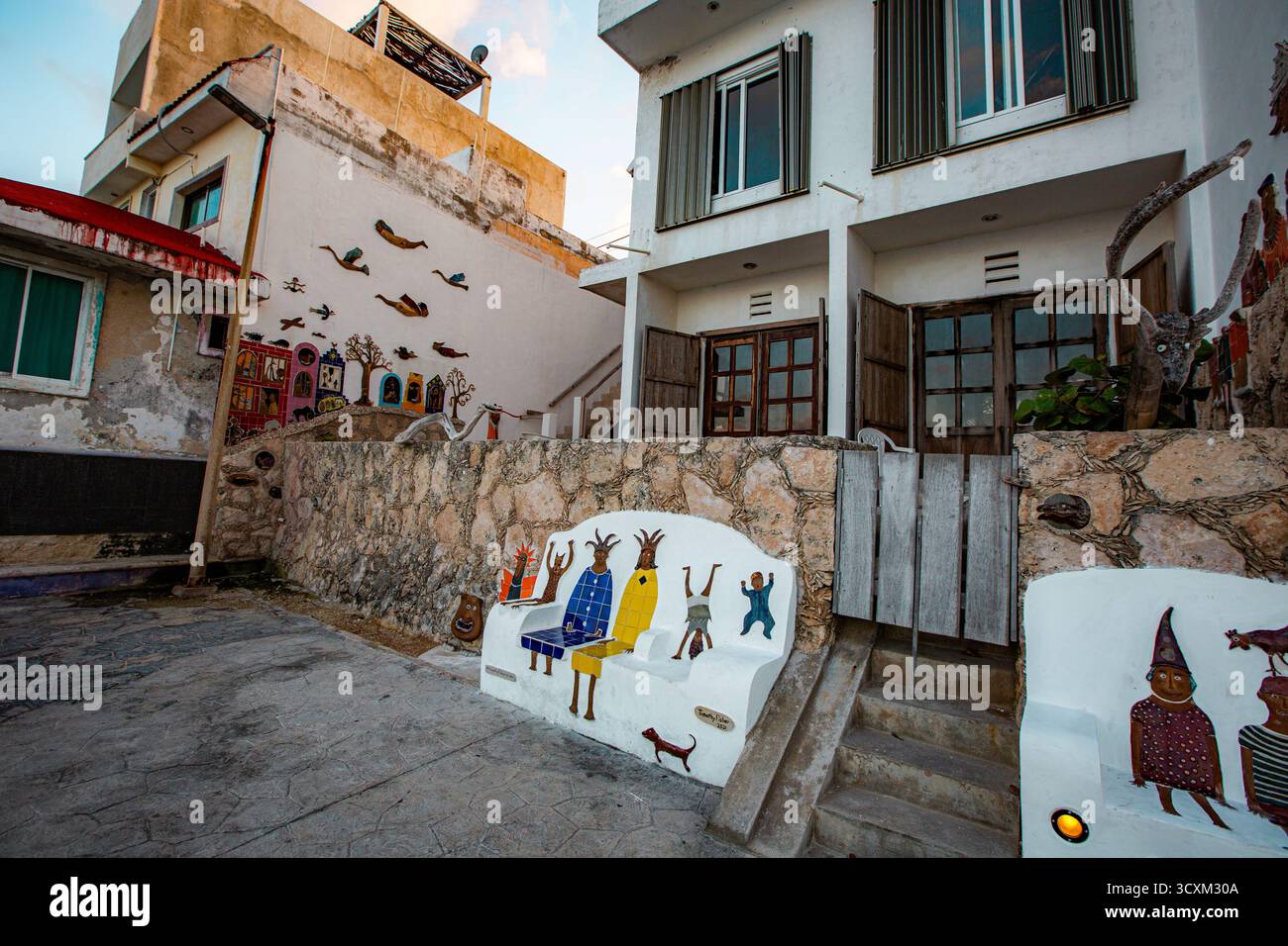 Isla Mujeres, Cancun, Mexico White house with a mural of people on the ...