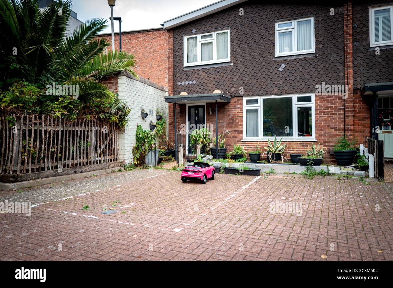 Toy car left in parking space outside house hi-res stock photography ...