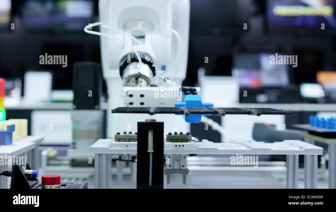 Robotic arm moving object in modern factory. Media Stock Photo - Alamy