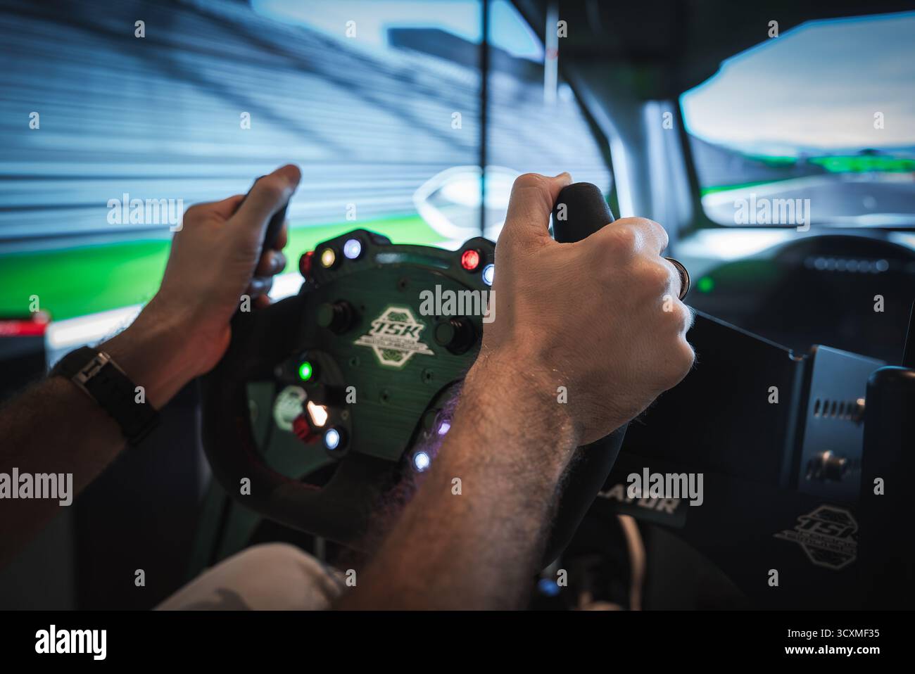 Close up of hands on racing simulator wheel with LEDs and shifters ...
