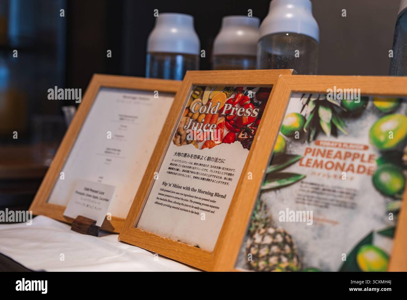 Hotel cafe countertop display with bilingual juice menus and bottles ...