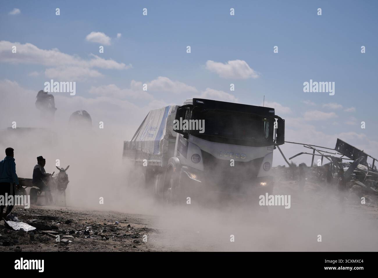 Trucks carrying aid from the World Food Programme (WFP) drive through ...