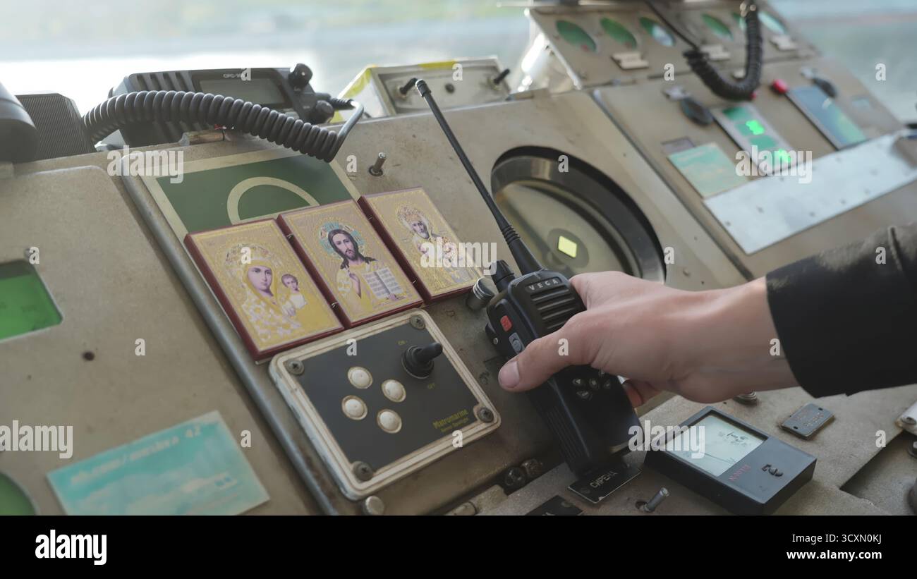 Ship captain communicating on radio in the wheelhouse. Clip Stock Photo ...