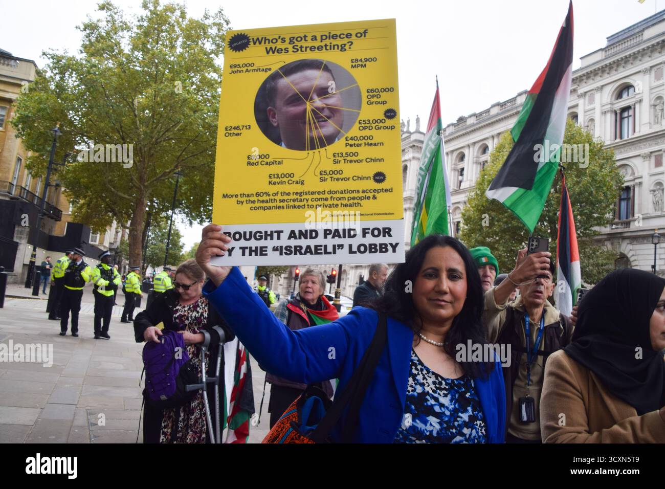 London, UK. 15th October 2025. Dr REHIANA ALI holds a sign with alleged ...