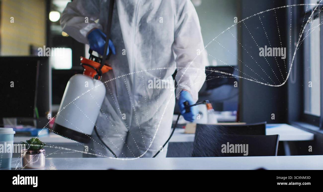 Spraying cleaning worker wearing protective suit disinfecting office ...