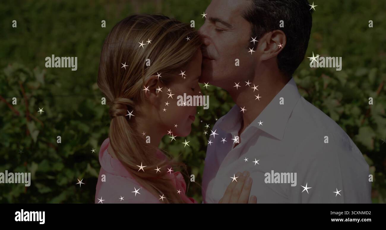 Planting forehead kiss, couple holding close in sunny vineyard, wearing ...
