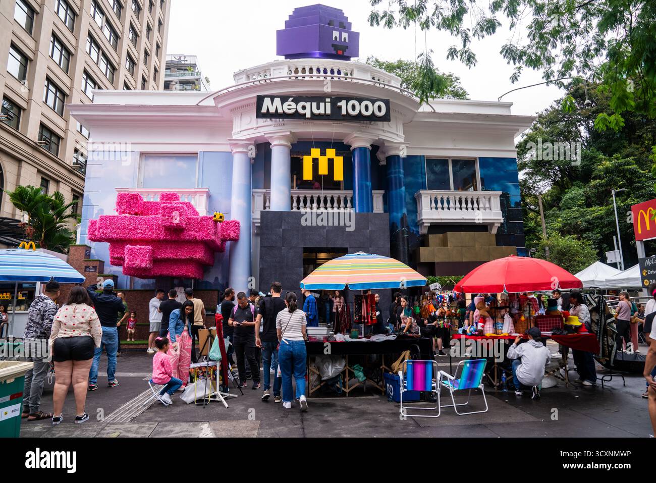An establishing shot of crowds in front of Méqui 1000, during a ...