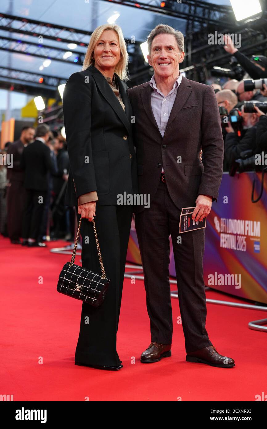 Rob Brydon and Clare Holland pose for photographers upon arrival at the ...