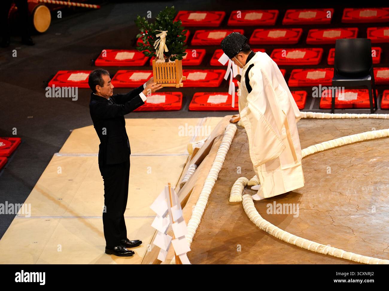 A gyoji performs the blessing of the sumo ring on day one of the Grand ...