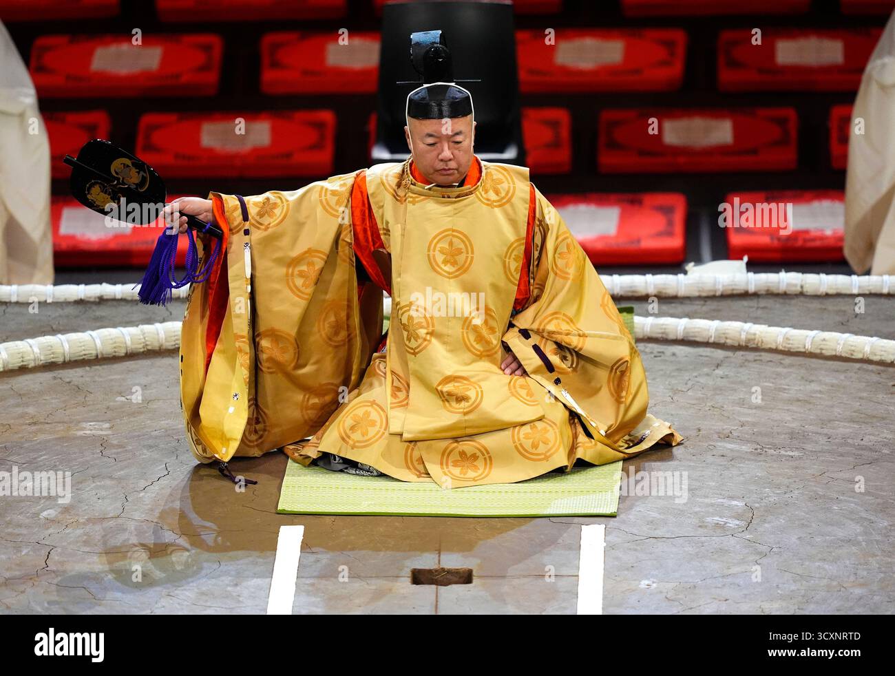 A gyoji performs the blessing of the sumo ring on day one of the Grand ...