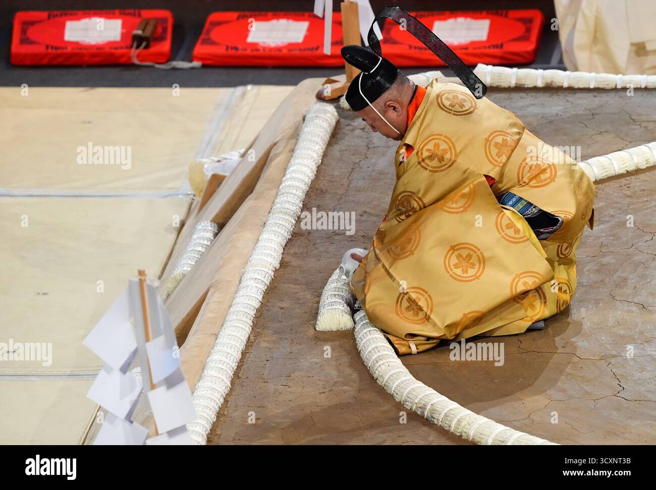 A gyoji performs the blessing of the sumo ring on day one of the Grand ...