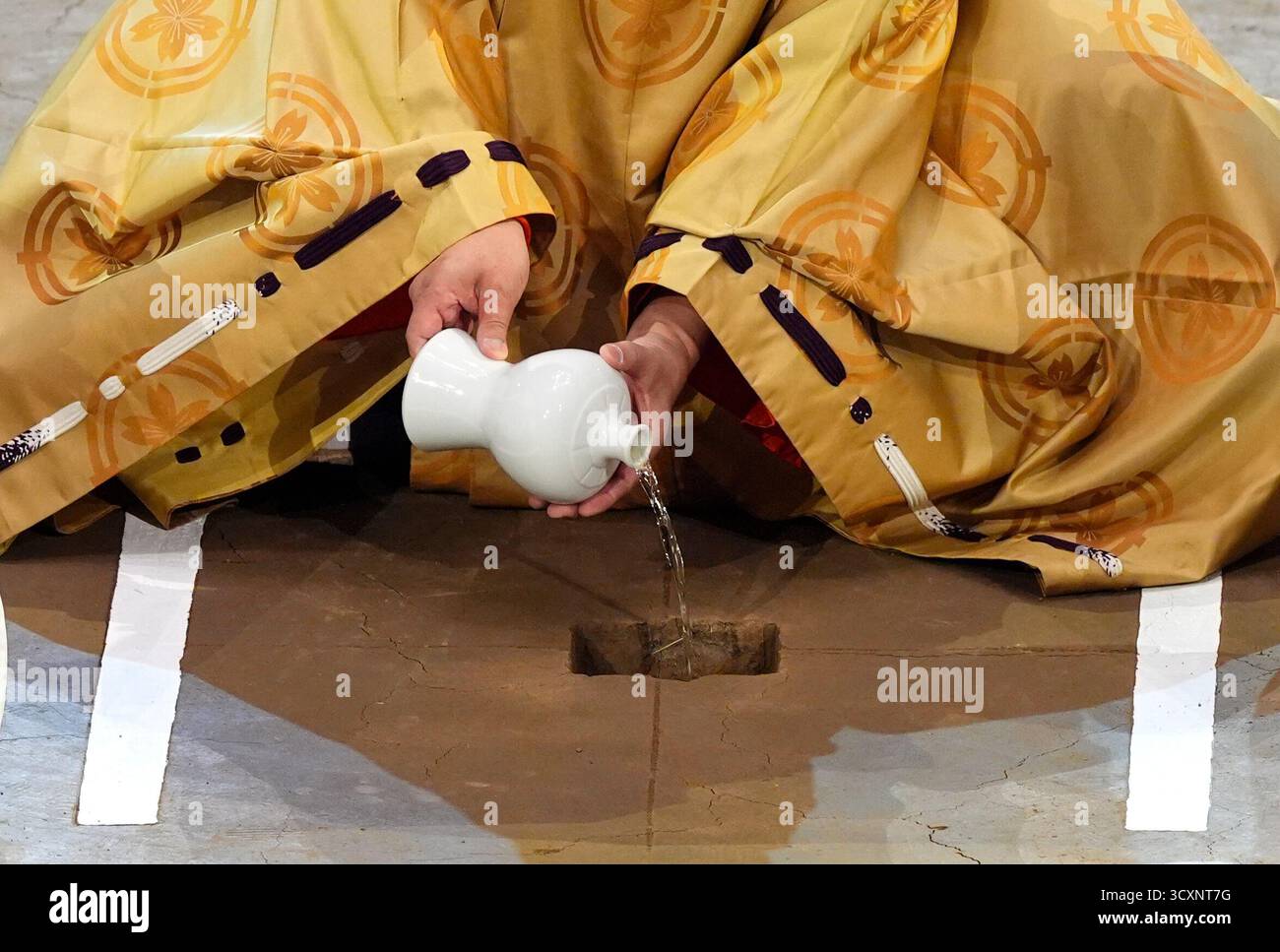 A gyoji performs the blessing of the sumo ring on day one of the Grand ...