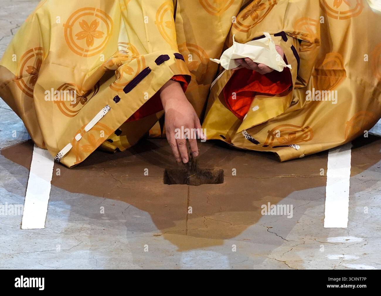 A gyoji performs the blessing of the sumo ring on day one of the Grand ...