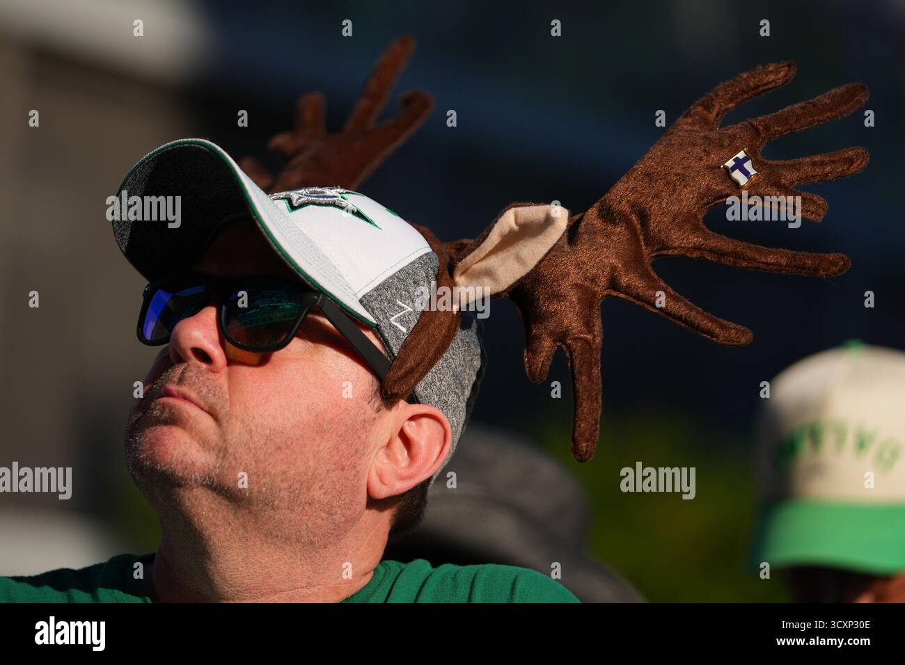 Steven Calhoun, of Mansfield, Texas, wears moose ears while waiting for ...