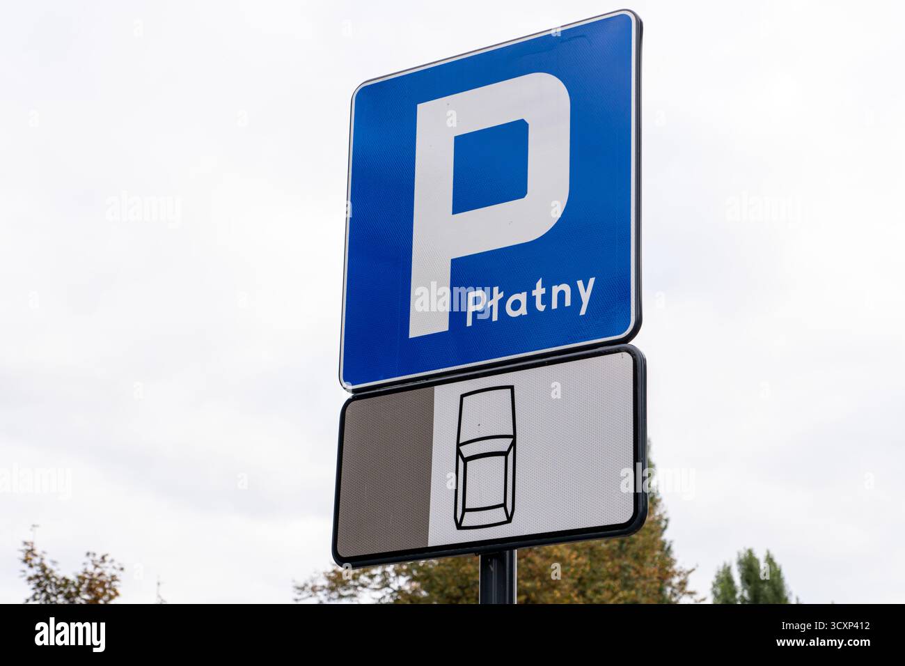 Paid parking sign with additional instructions for vehicle parking ...