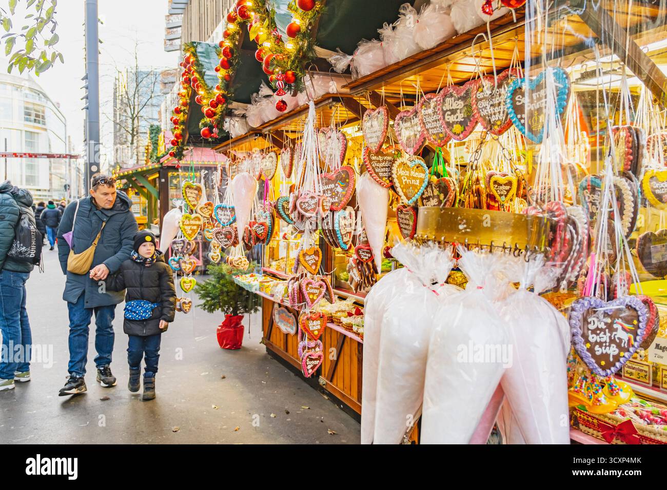 Festive Christmas market with decorated trees, wooden stalls, and ...