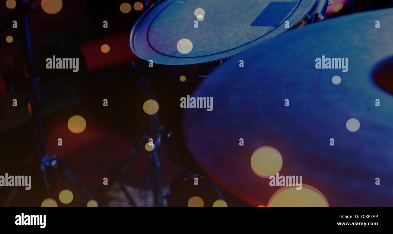 Showcasing drum kit bathing in warm bokeh lights on dim stage, with tom ...
