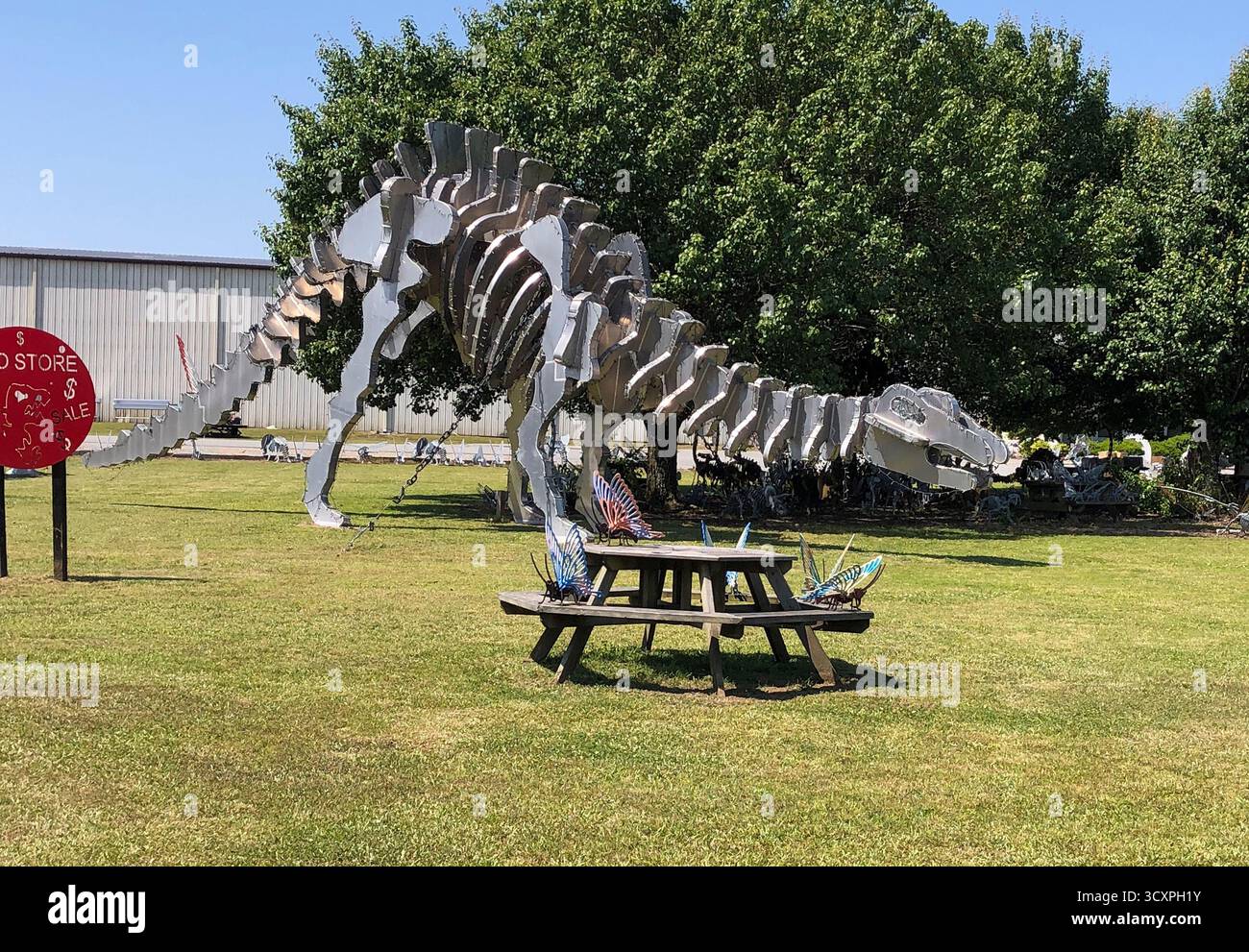 Giant metal dinosaur skeleton sculptures outside Benton & Sons ...