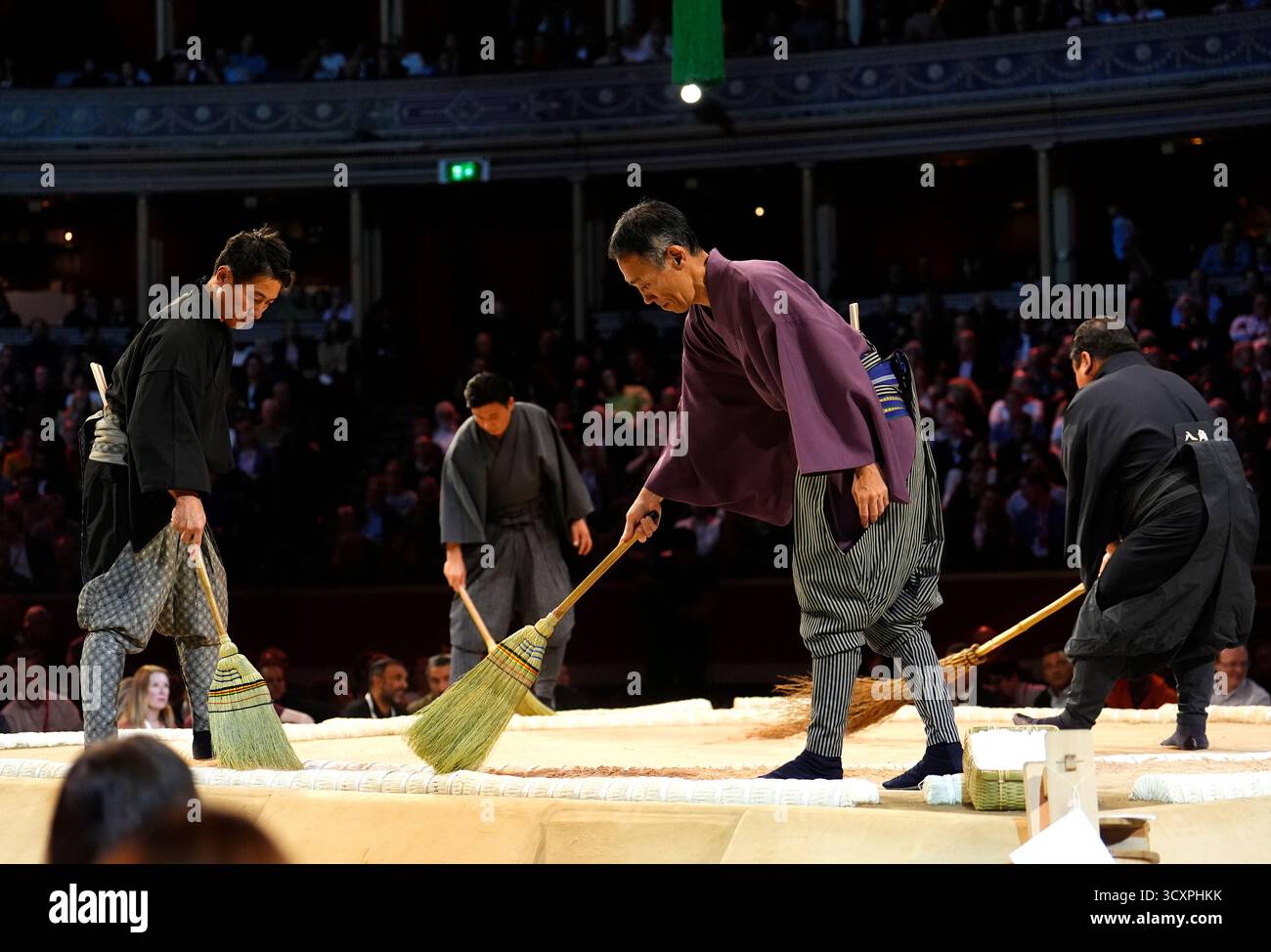 Gyoji sweep the ring on day one of the Grand Sumo Tournament at the ...