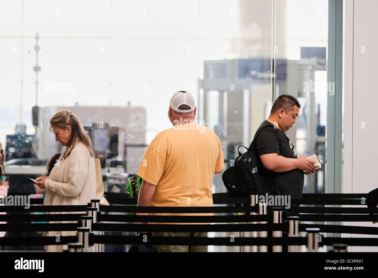 Travelers wait in line for screening at Louis Armstrong New Orleans ...