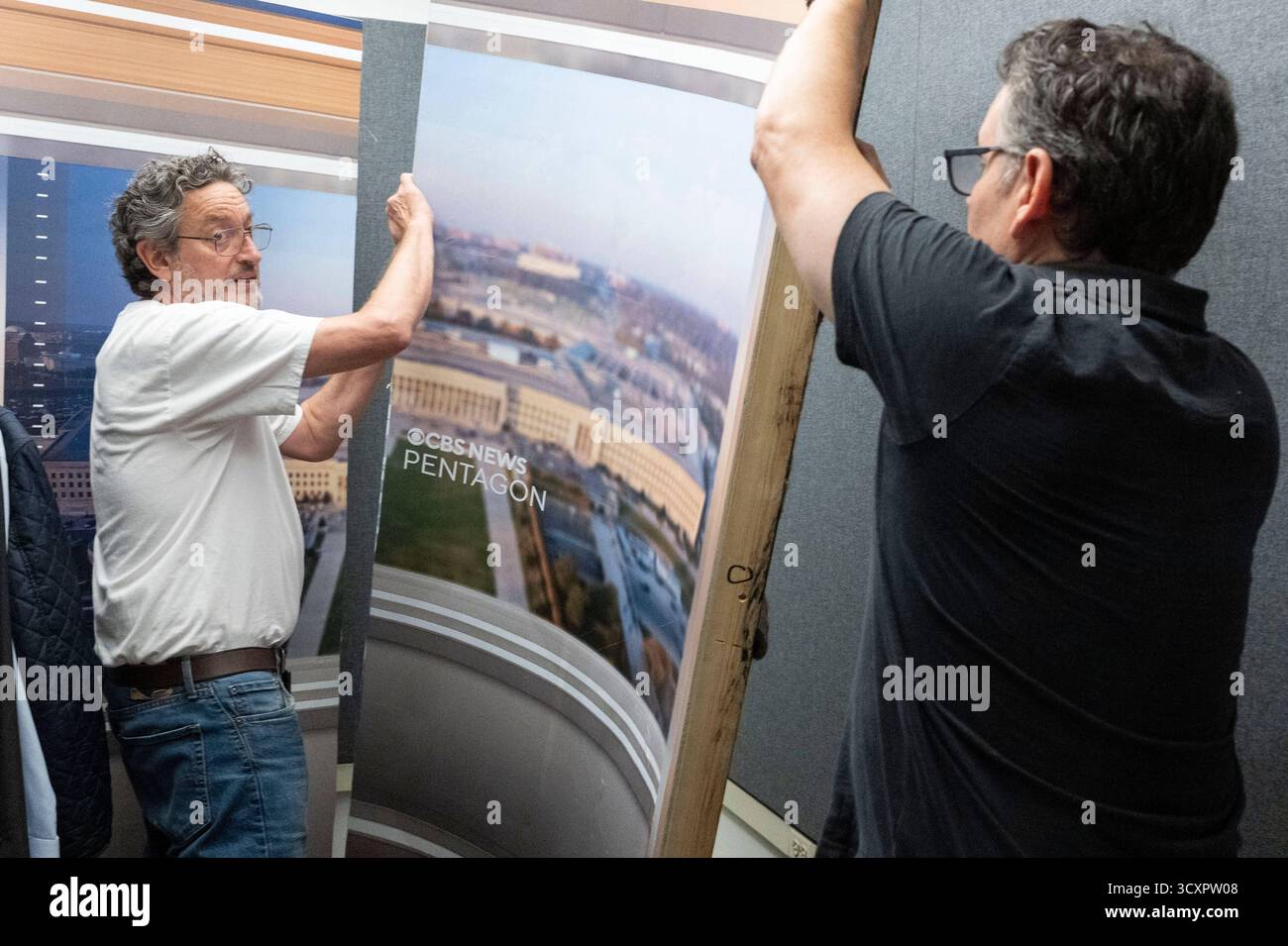 CBS crew members pack up the contents of their broadcast booth in the ...