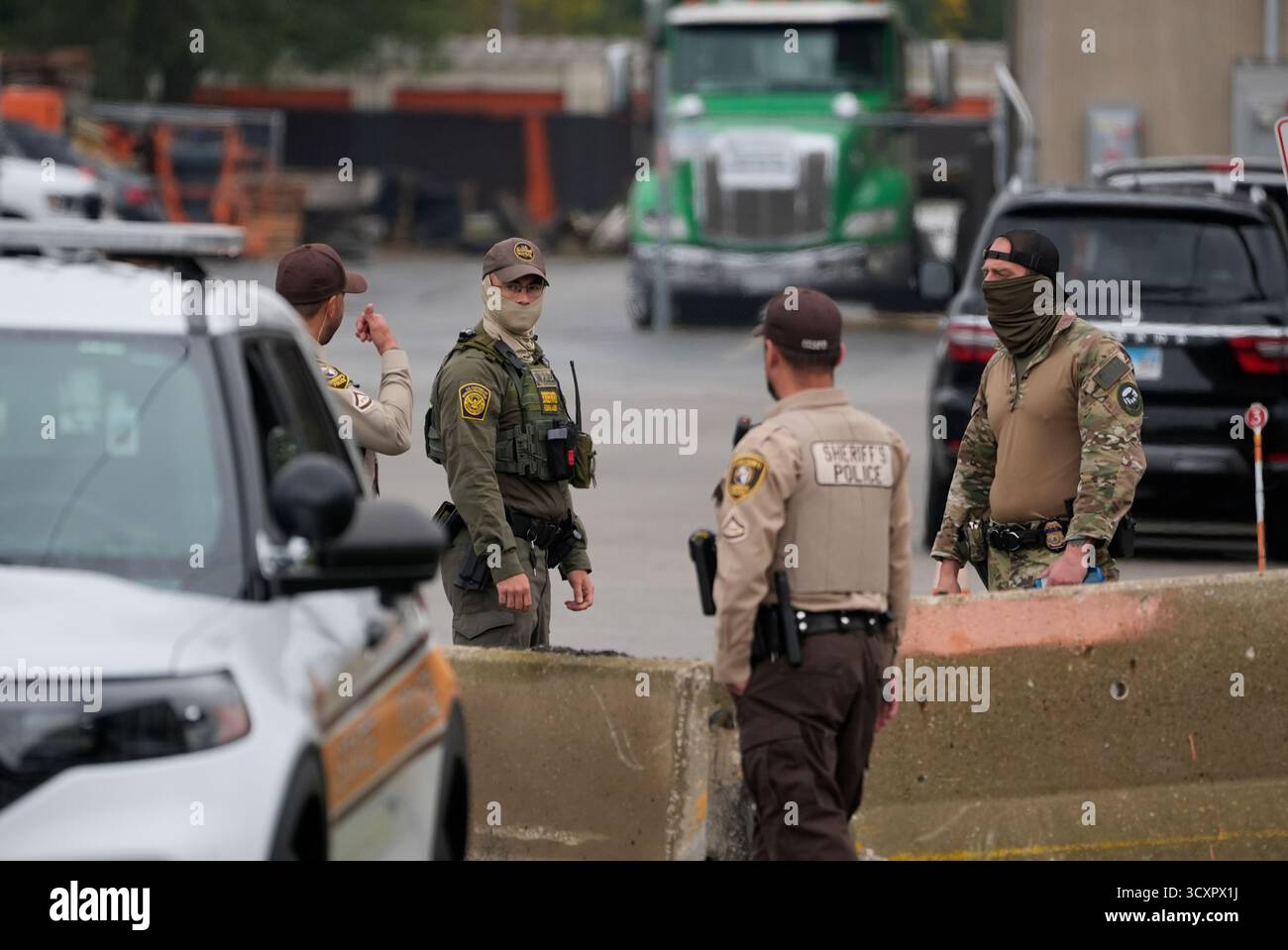 Cook County Sheriff's deputies and federal agents talk outside the U.S ...