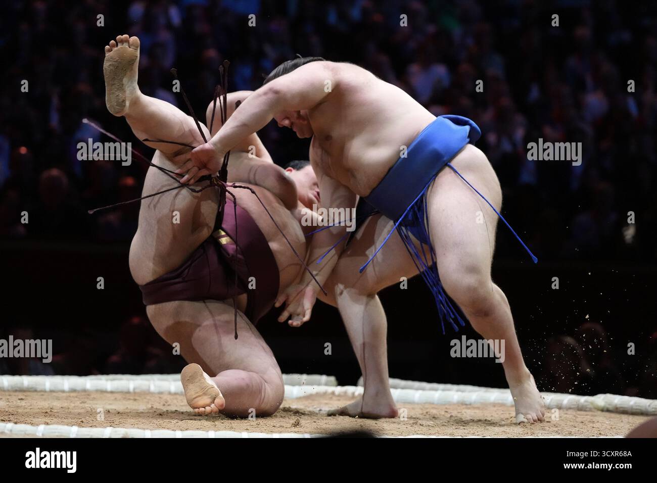 Aonishikli throws Atamifuji during a bout at The Grand Sumo Tournament ...