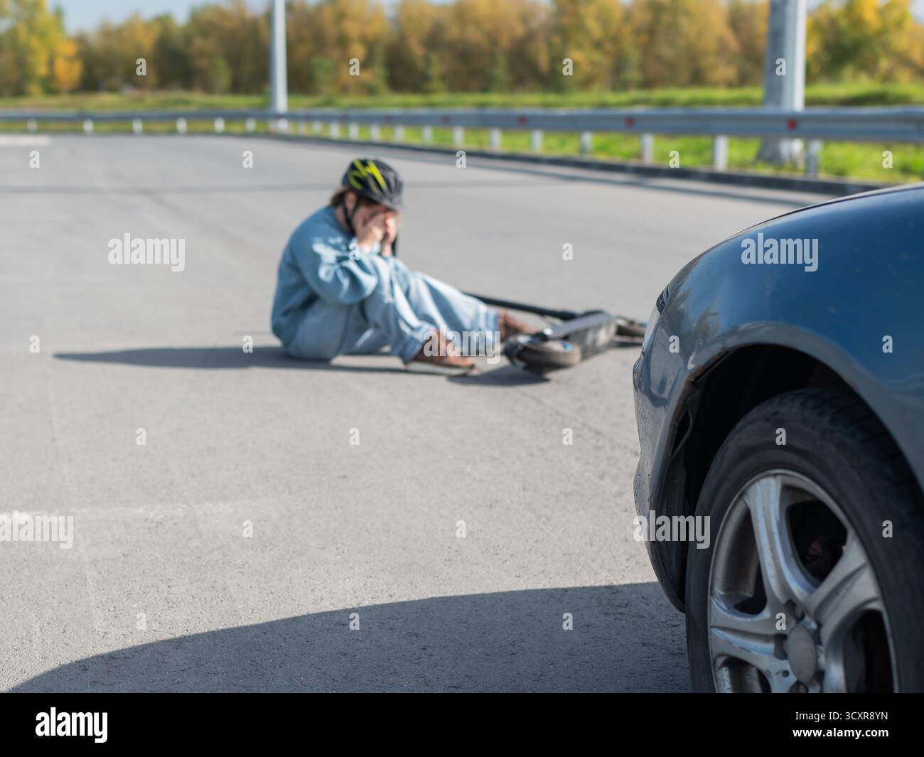 A Caucasian woman on a scooter after being hit by a car Stock Photo - Alamy