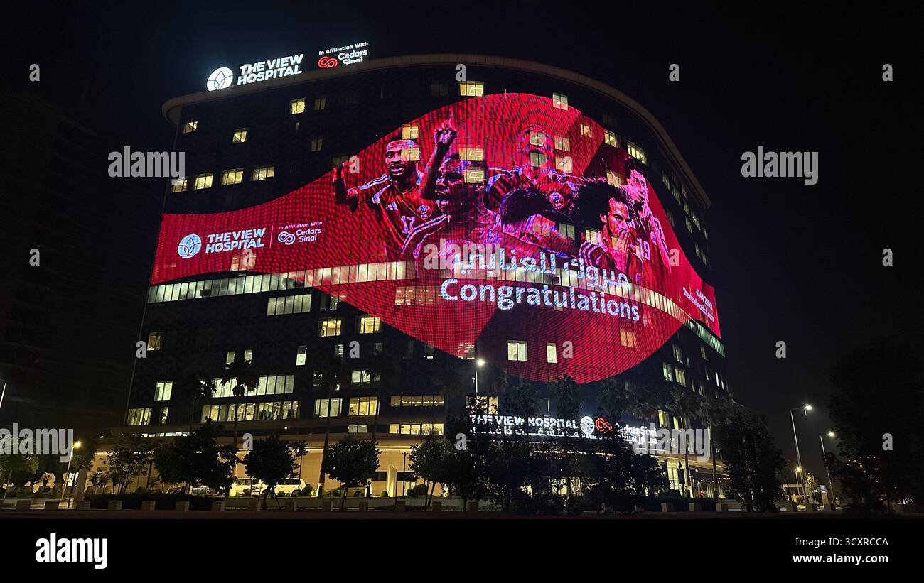 A view of a Hospital illuminated with images of the Qatari national ...