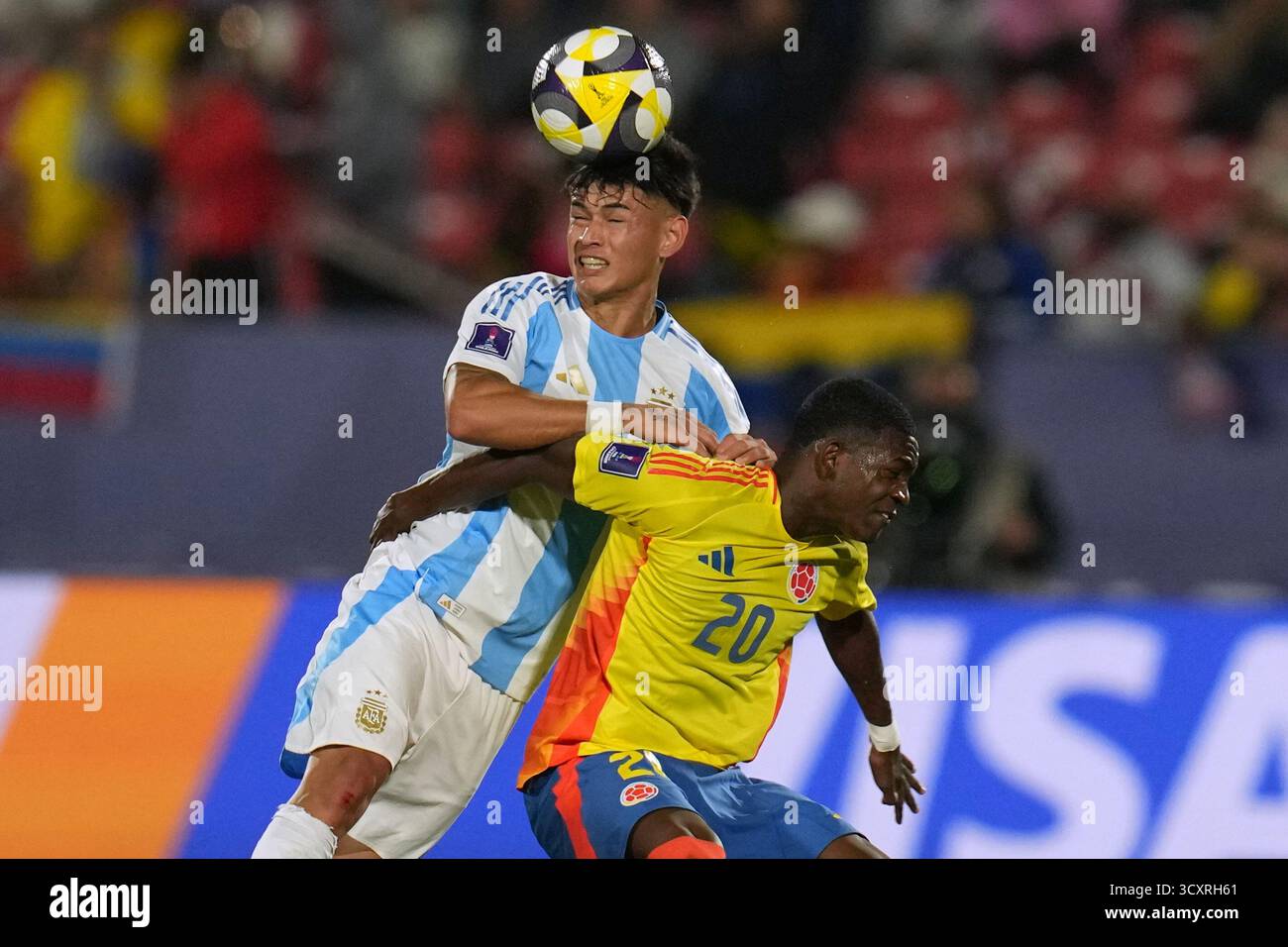 Argentina's Julio Soler heads the ball over Colombia's Joel Canchimbo during a FIFA U-20 World ...