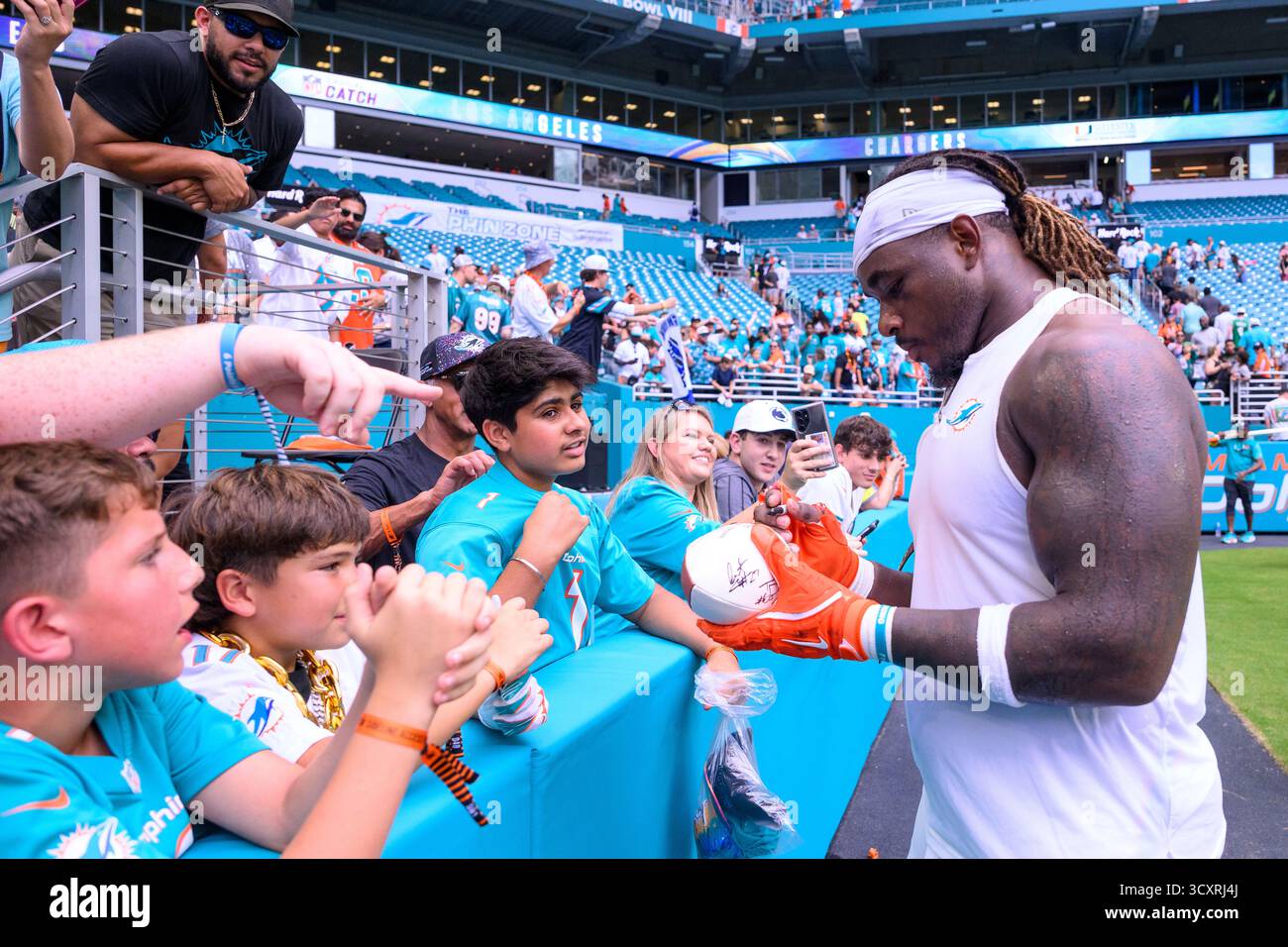 Miami Dolphins offensive lineman Aaron Brewer (55) signs autographs for ...