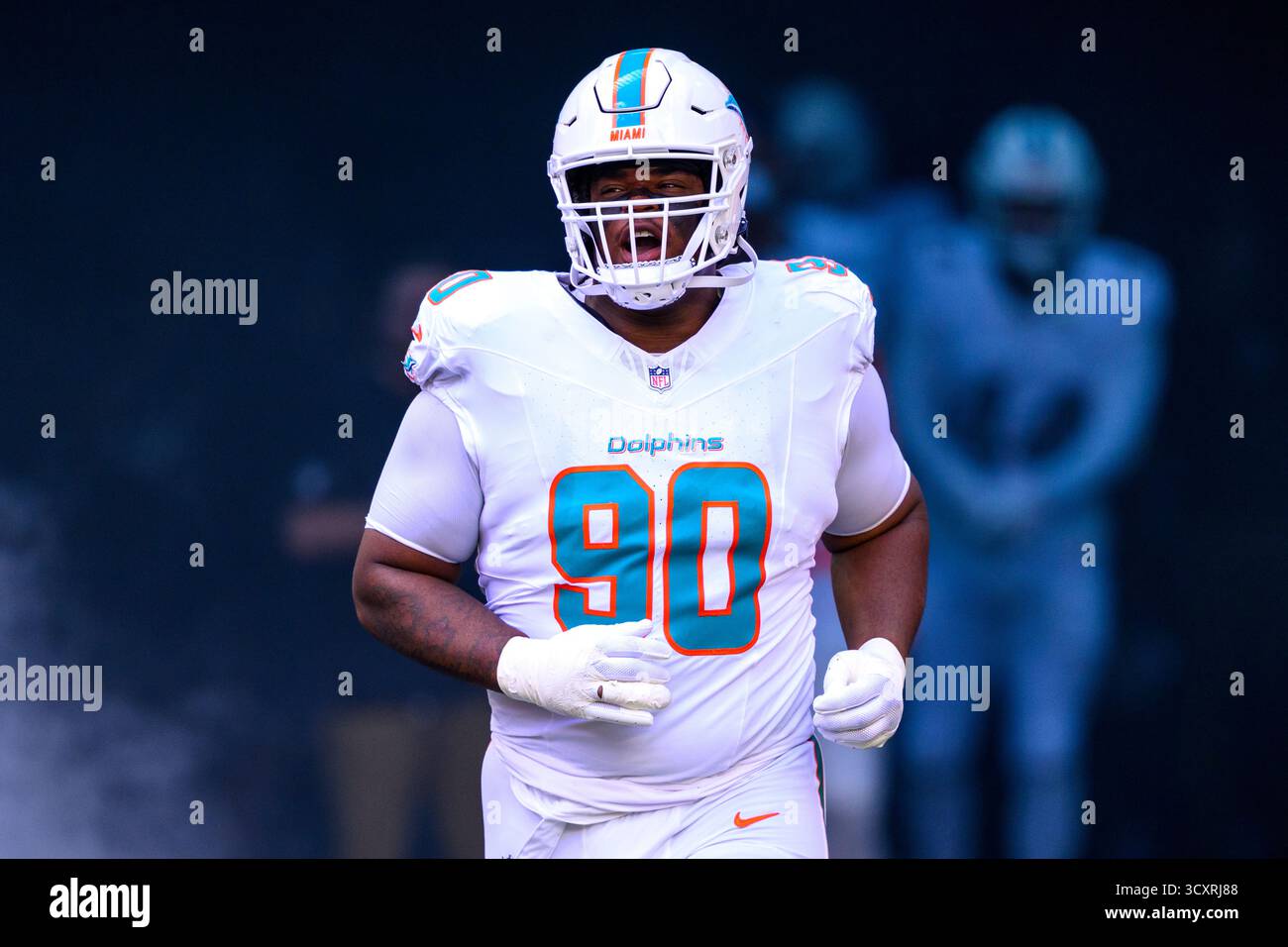 Miami Dolphins defensive tackle Kenneth Grant (90) runs onto the field ...