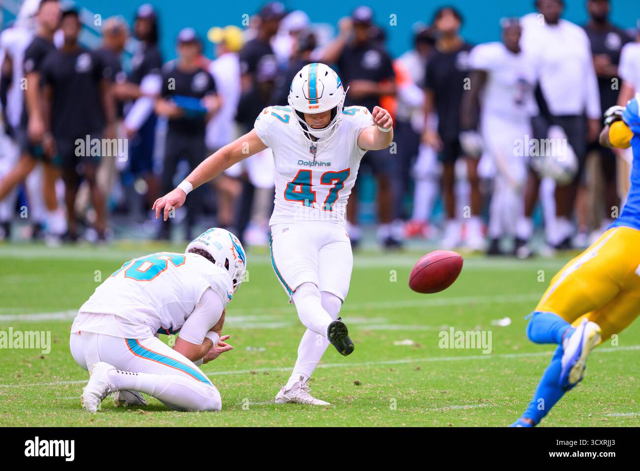 Miami Dolphins punter Jake Bailey (16) holds the ball as kicker Riley ...